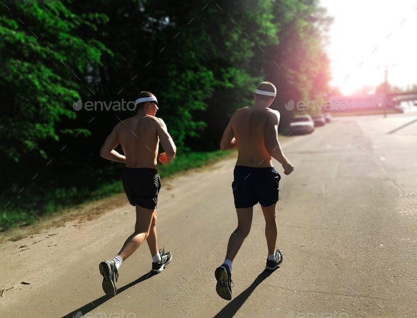 Twins running together by the park road Stock Photo by Leonteena ...