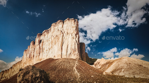 White Rock Landscape with Blue Sky and Clouds Stock Photo by yanaiskayeva