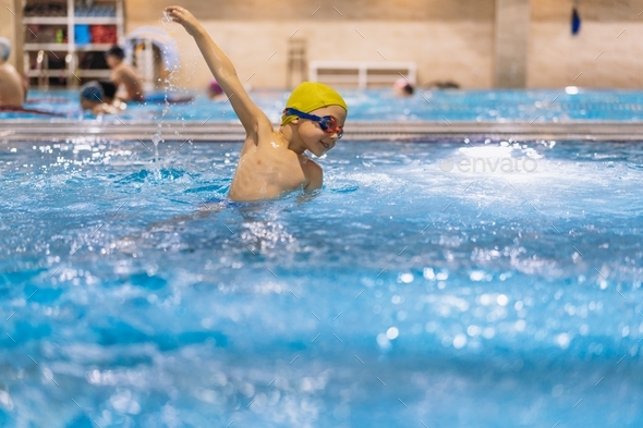 Cute little child splash in a swimming pool having fun Stock Photo by ...