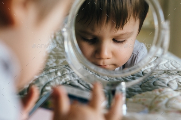 cute little boy using smartphone and reflecting in a mirror Stock Photo ...