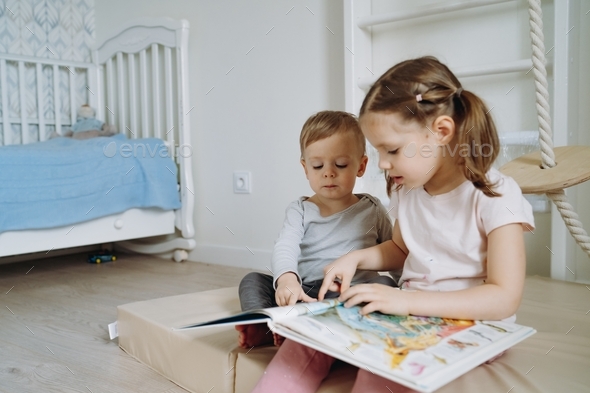 brother and sister reading a book together Stock Photo by uraneva ...