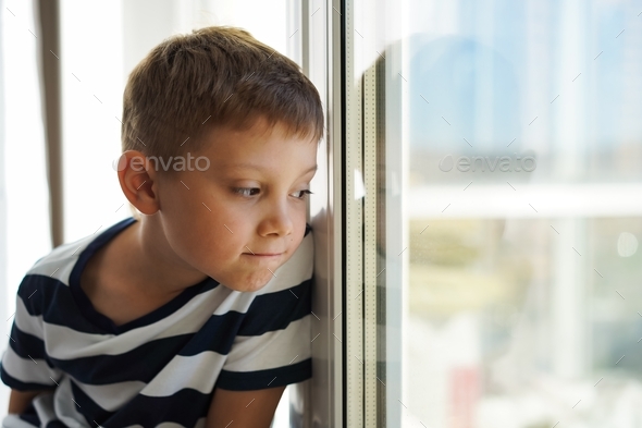 Little boy sitting by the window Stock Photo by uraneva | PhotoDune