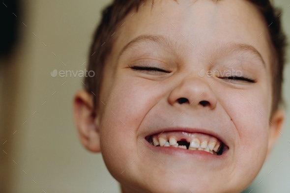 Cute little boy smiling demonstrating lost baby tooth Stock Photo by ...
