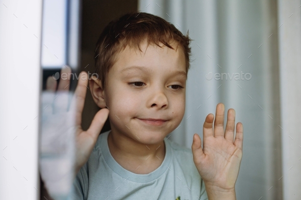 cute little boy looking through window with funny face Stock Photo by ...