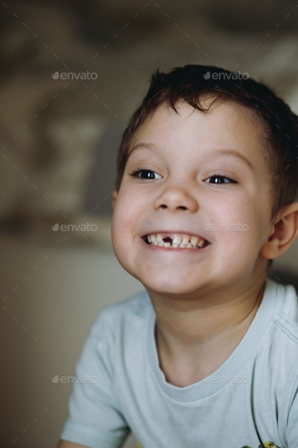 cute little boy smiling demonstrating lost baby tooth Stock Photo by ...