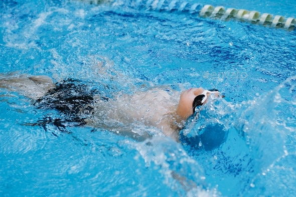 Cute little boy swimming back struck in swimming pool Stock Photo by ...