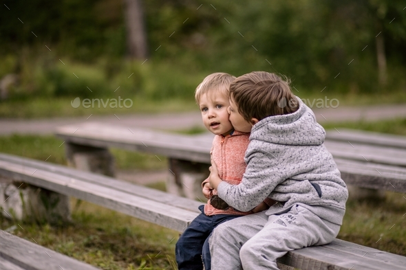Boy kissing his little brother on cheek. Brotherhood concept Stock Photo by uraneva