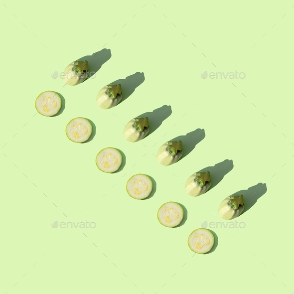 Zucchini isolated on a green background. Cut parts of zucchini on a ...