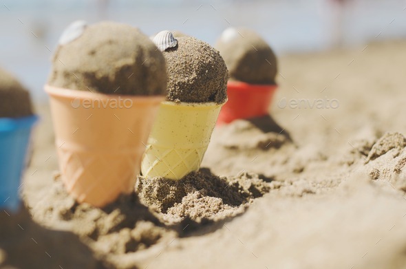 Colorful sand ice cream made by kids on the sea background sunny day ...