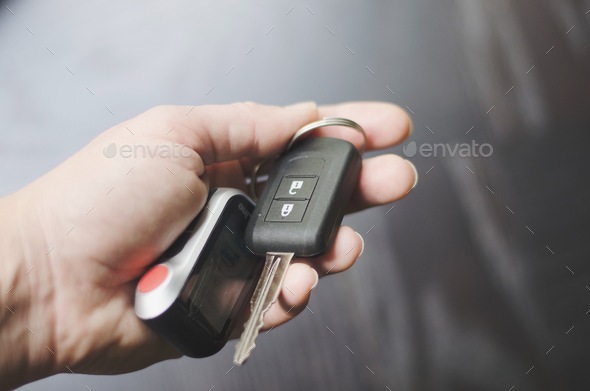 Woman hand car keys handful grey background Stock Photo by yuliavorlova
