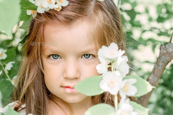 Portrait of beautiful little girl 4-7 years old with blue-green emerald ...