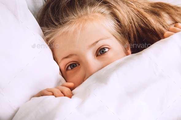 Child hiding under duvet in bed Stock Photo by irinarudaieva1082 ...