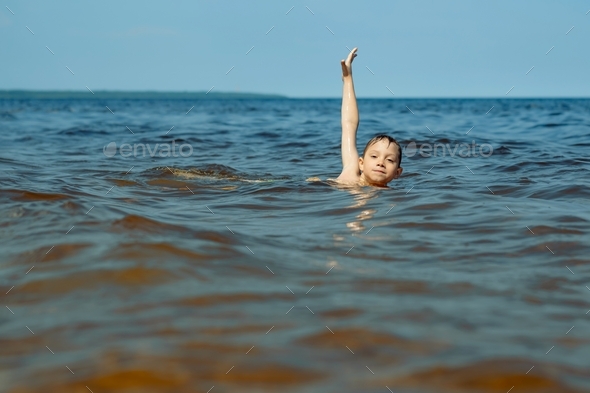 Little boy learning to swim in sea Stock Photo by uraneva | PhotoDune