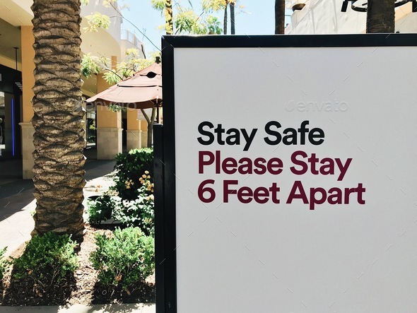 Sign at the shopping mall that reminds people to stay safe and stay six ...