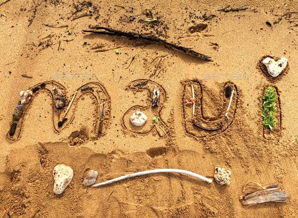 Maui words in the wild written in the sand and used sea shells, plants ...