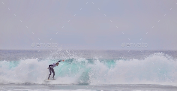 Lone surfer in a sea of awesome, touching his hand on the wave Stock ...