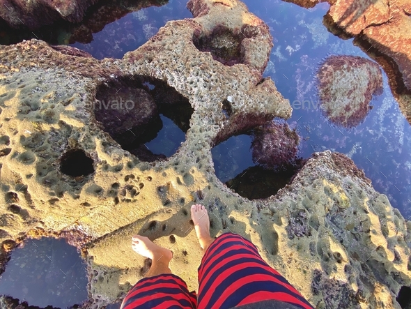 Walking at low tide looking for sea creatures in the tide pools. Stock ...