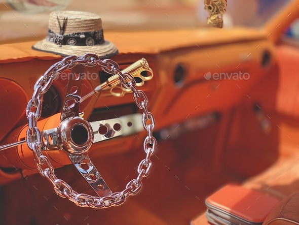 Custom low rider with silver chain steering wheel and orange interior ...