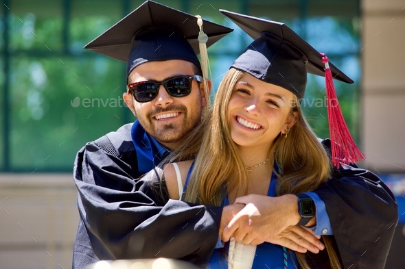 Graduates on graduation day wearing their cap and gowns ready to start ...