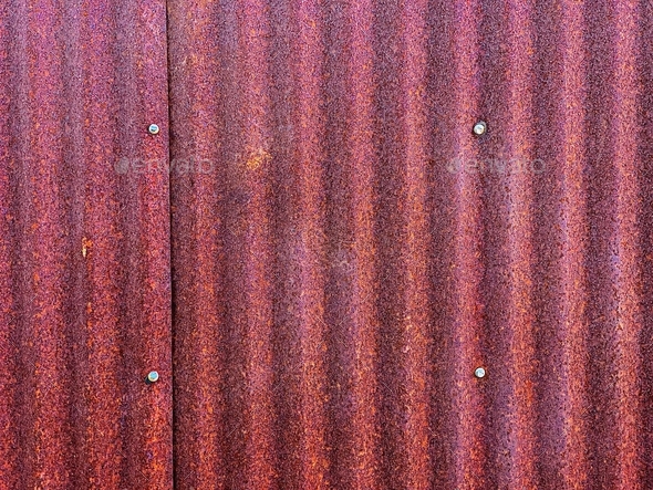 Rusted, corrugated metal with ridges used as a background or wallpaper ...
