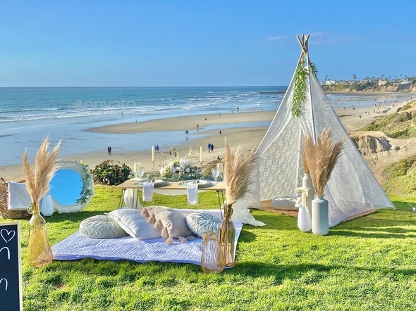 Beautiful and romantic grass picnic setup on a cliff overlooking the ...