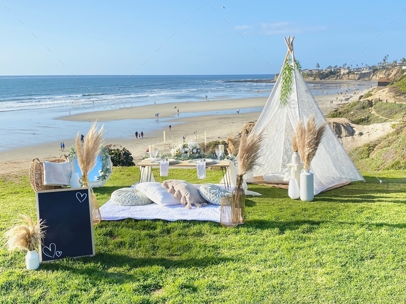 Beautiful and romantic grass picnic setup on a cliff overlooking the ...