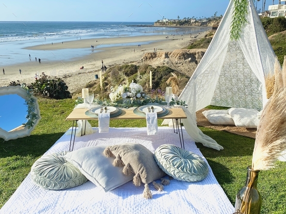 Beautiful and romantic grass picnic setup on a cliff overlooking the ...