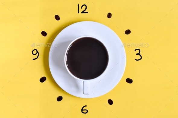 A cup of coffee on a yellow background (table) with watch face at 6 am ...