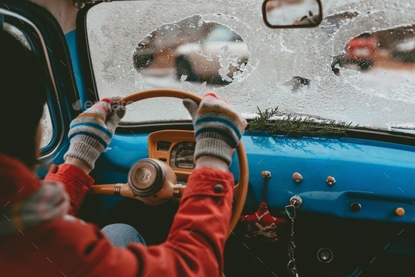 driver in a red jacket rides a blue retro car behind the wheel Stock ...