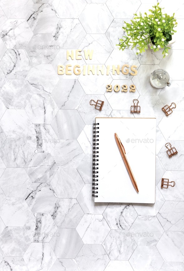 Flat lay concept with a notebook planning of new beginnings for 2022 ...