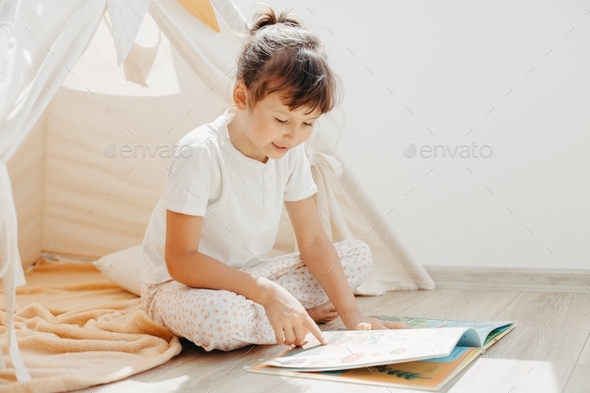 Preschooler child reading book at home Stock Photo by sonyashna | PhotoDune