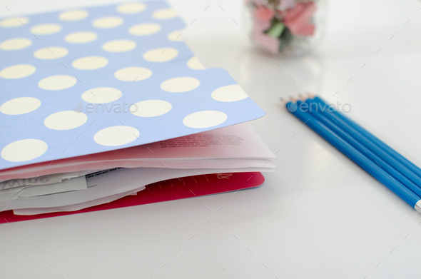 Desktop desk with a folder of paperwork papers, pencils and binder ...