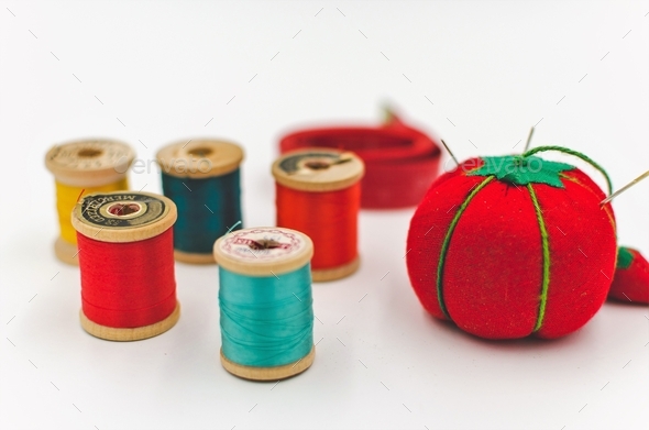 Vintage bright colorful antique sewing notions on a white background ...