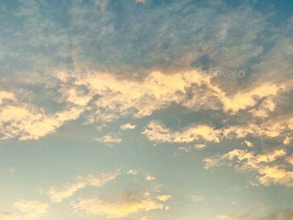Clouds at dawn with the sky starting to lighten and the sun making the ...