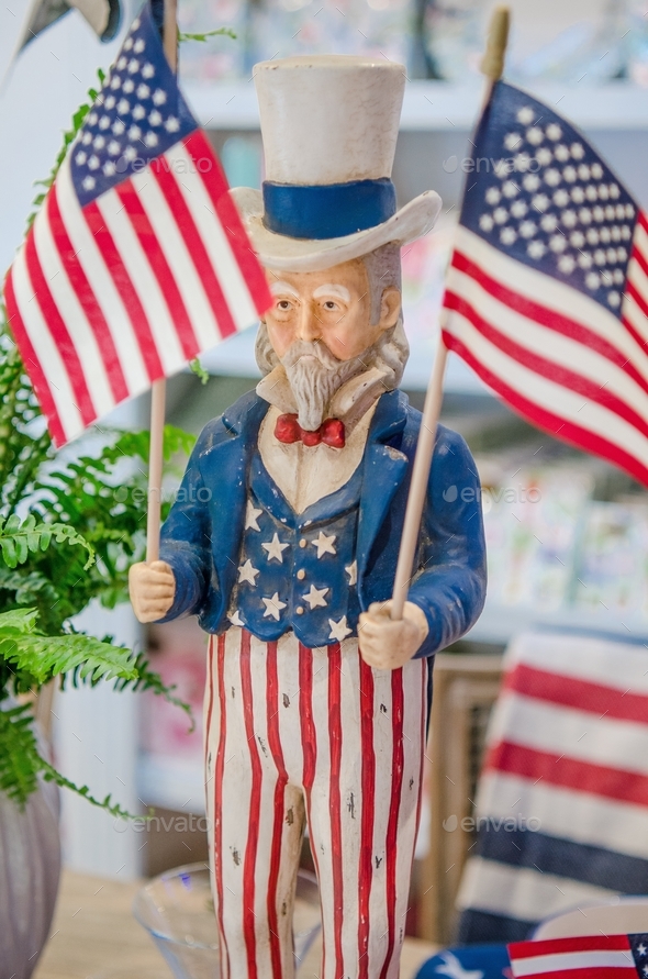 Uncle Sam figure holding a red white and blue American flag for Fourth ...
