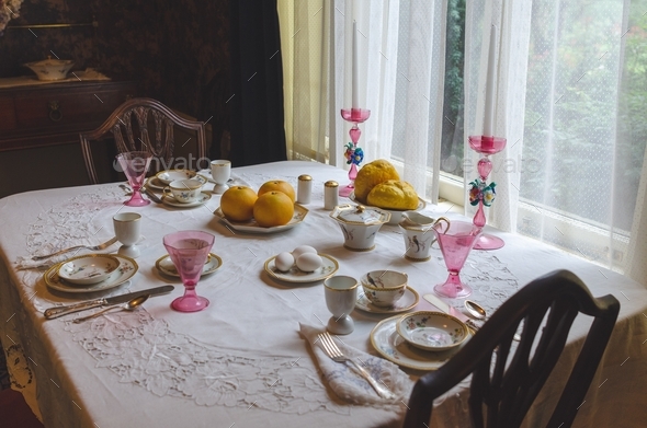 Dining room table set for a fancy breakfast meal at home with vintage ...