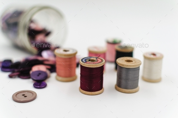 Vintage sewing notions thread and buttons on a white background ...