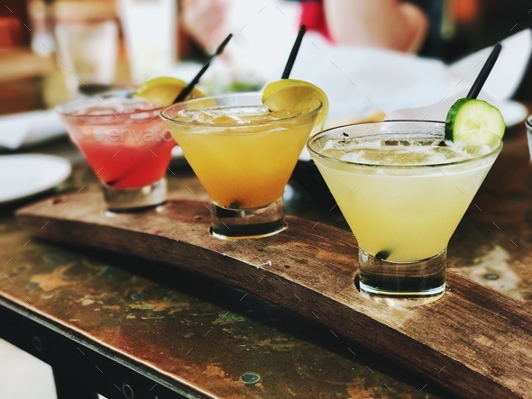 Colorful margaritas lined up at a bar, restaurant. Alcohol cocktails at ...
