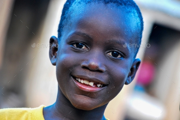 Little african boy smiling into the camera Stock Photo by leencrombez