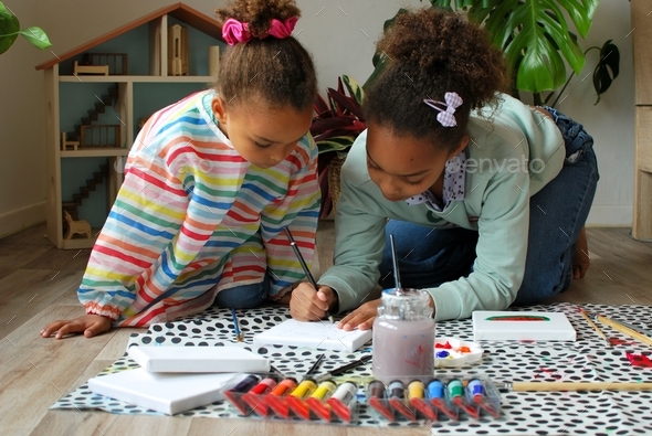 Siblings (mixed race) drawing and painting (paintbrush) and colorful ...