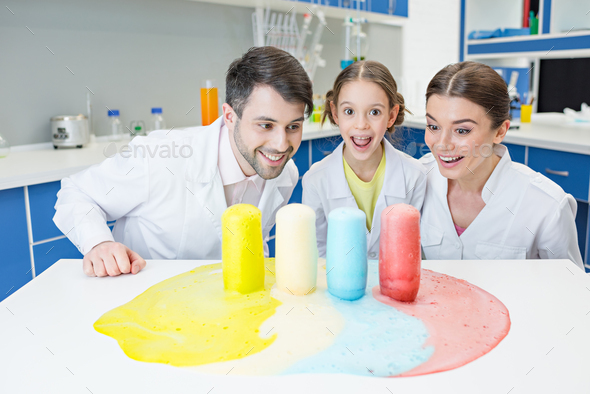 portrait of cheerful teachers and girl student scientists making ...