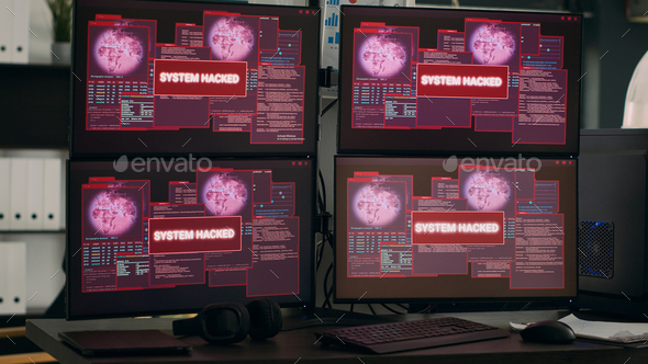Multiple monitors displaying hacking warning alert after security ...