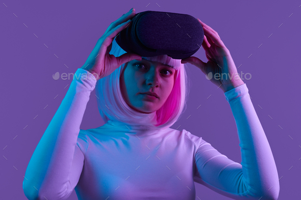 Futuristic female taking off VR headset Stock Photo by kegfire | PhotoDune