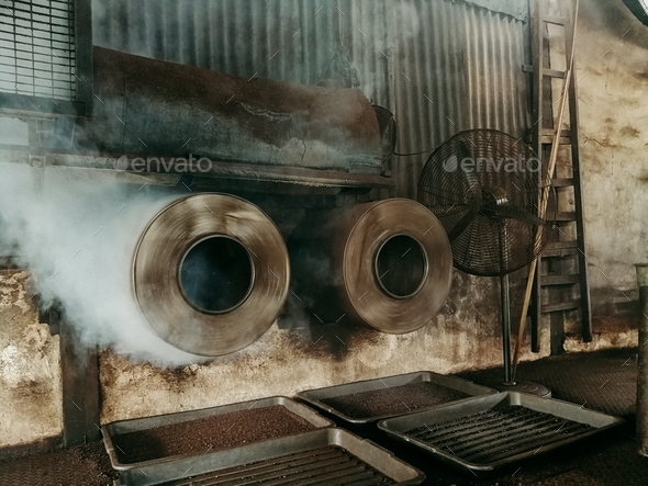 Coffee roaster spinning. Hot and smoke coming from the process. Stock ...