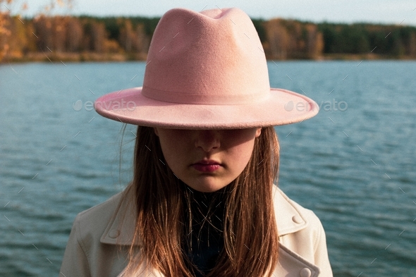 beautiful portrait of a girl in a felt hat by the lake.autumn. Fall ...