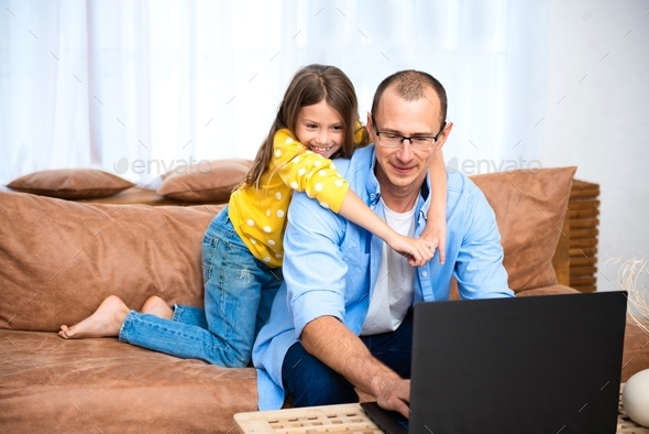 Father and daughter look at the computer monitor Stock Photo by ...