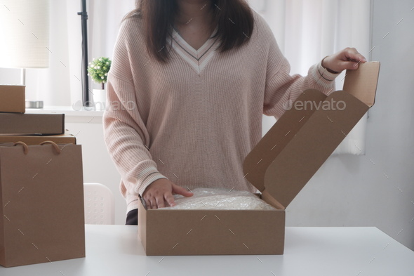 Women opening, wrapping package box for online shopping, buying ...