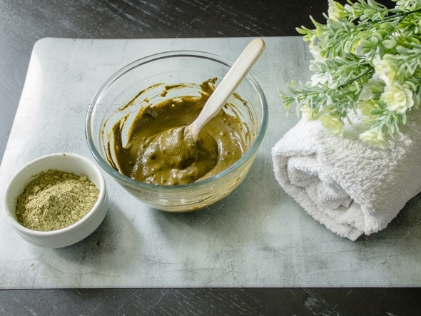 Henna dry powder, glass bowl with henna rehydrated, white terry towel ...