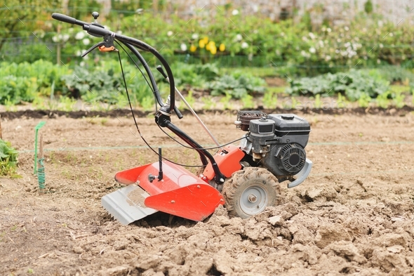 A plow plows the ground in the garden Stock Photo by o1559kip | PhotoDune