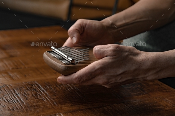 Girl playing a kalimba or mbira Stock Photo by Banyushka | PhotoDune